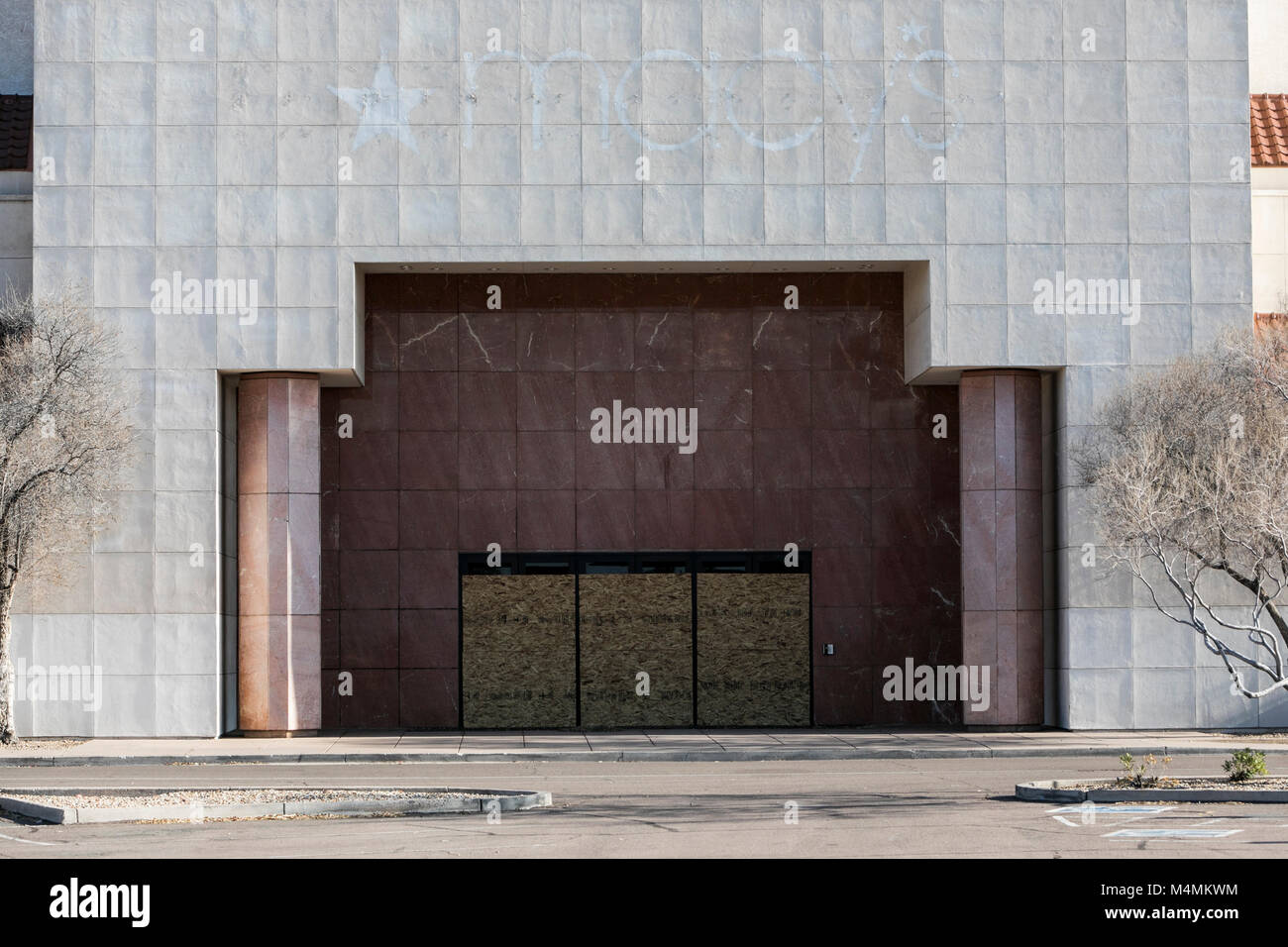 The faded outline of a logo sign outside of a now closed Macy's retail ...