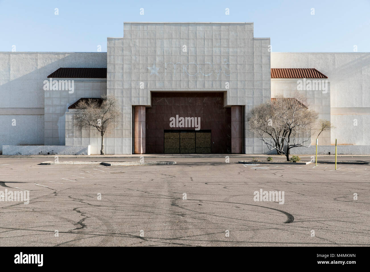 The faded outline of a logo sign outside of a now closed Macy's retail ...