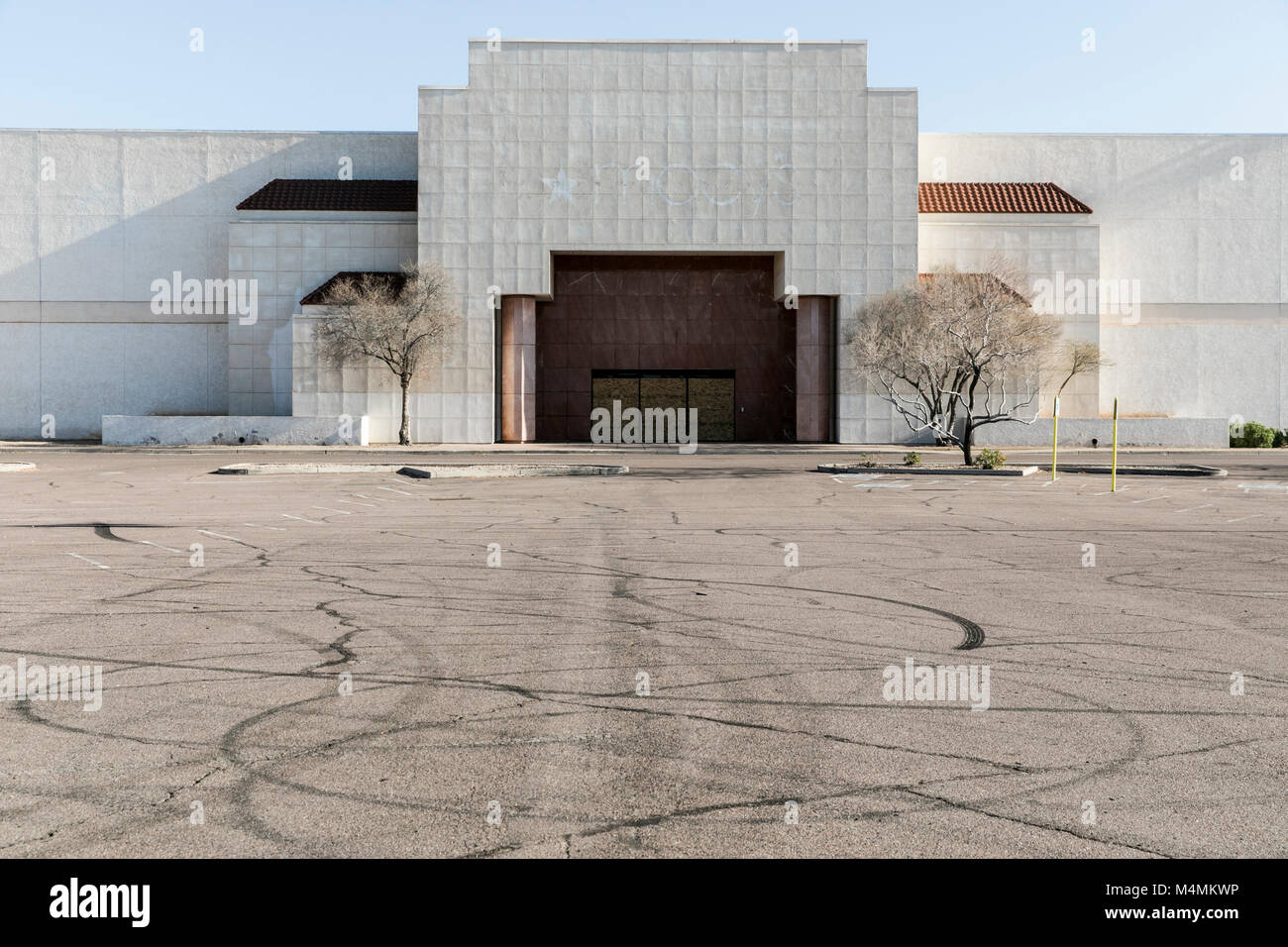 The faded outline of a logo sign outside of a now closed Macy's retail ...