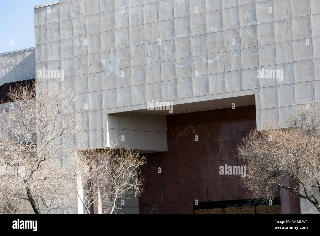 The faded outline of a logo sign outside of a now closed Macy's retail ...