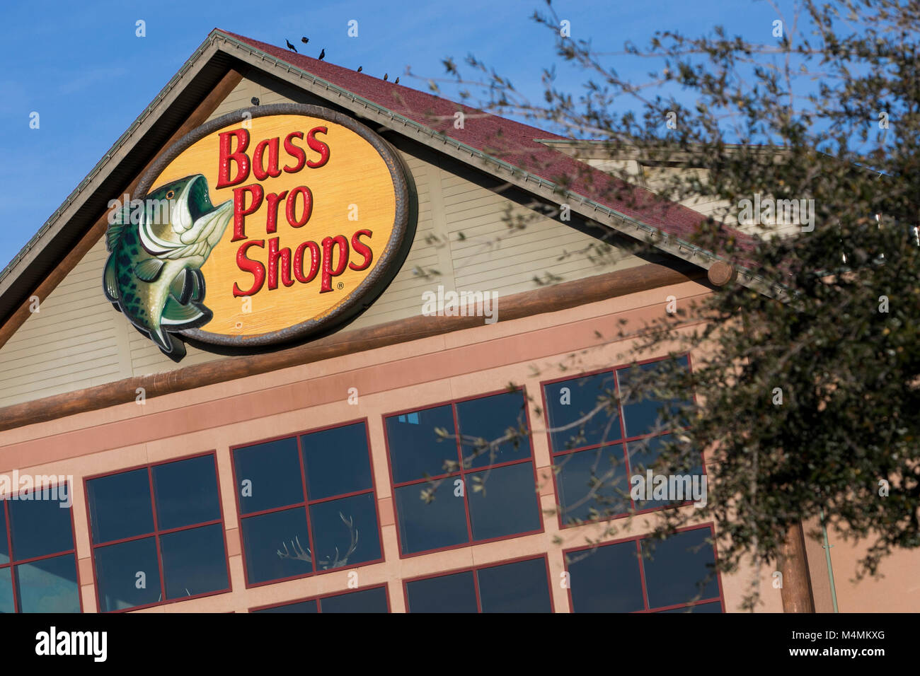 A logo sign outside of a Bass Pro Shops retail store in Mesa, Arizona ...