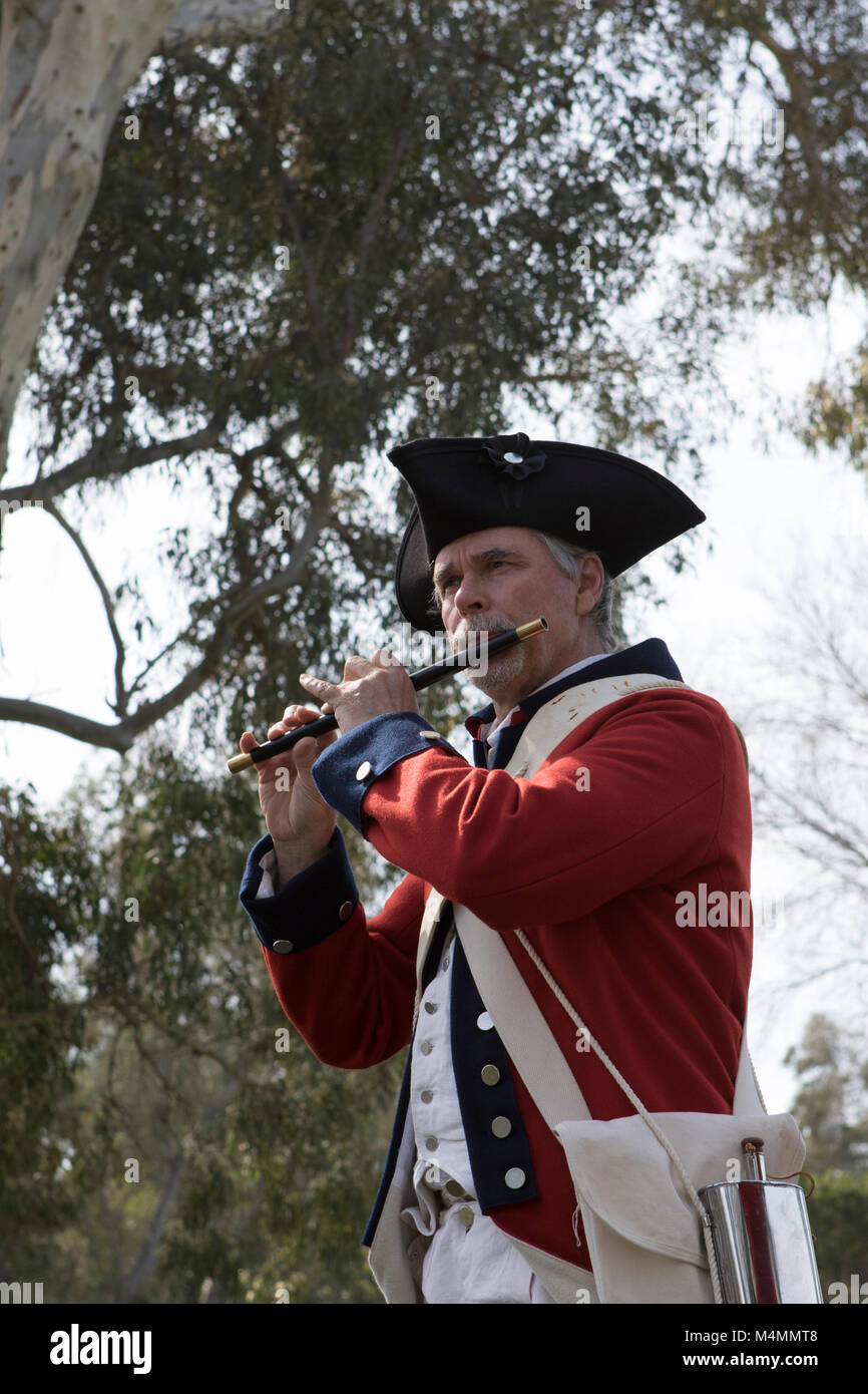 British redcoat soldier playing a fife during a reenactment of the ...