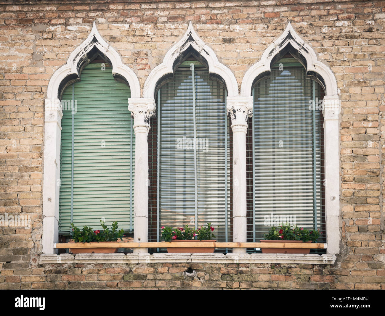 Old windows on a medieval palace facade in Verona, Italy Stock Photo ...