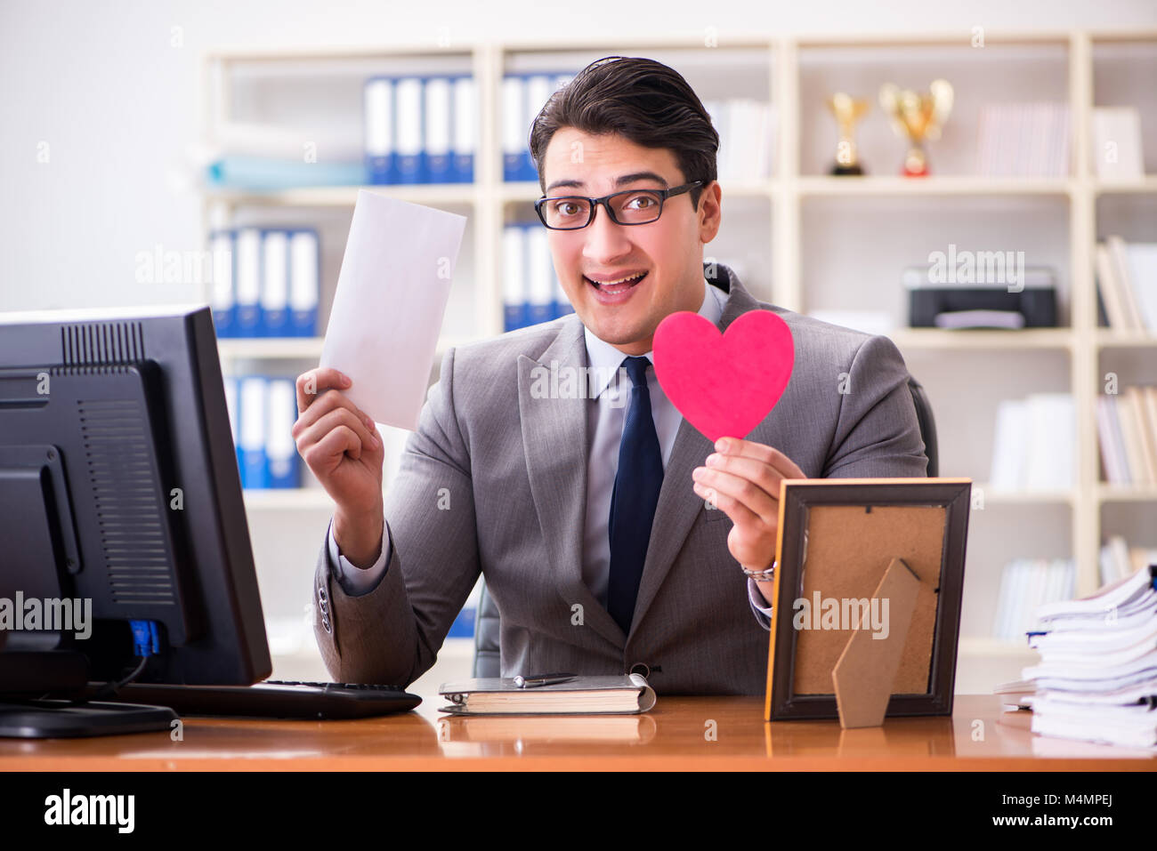 Businessman in saint valentine concept in office Stock Photo - Alamy