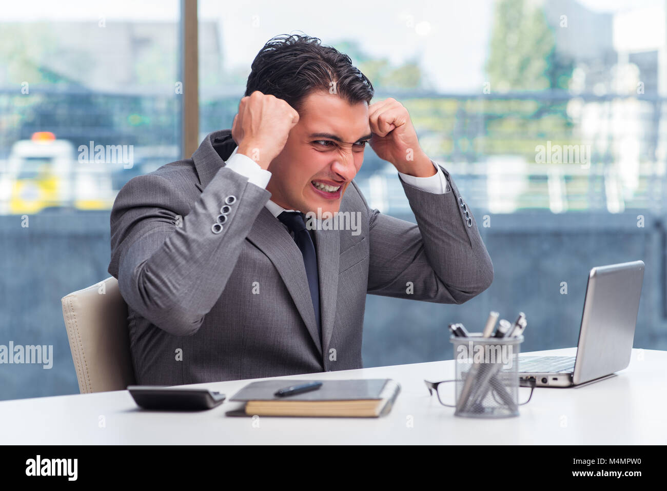 Busy angry businessman with heaps of paper Stock Photo - Alamy