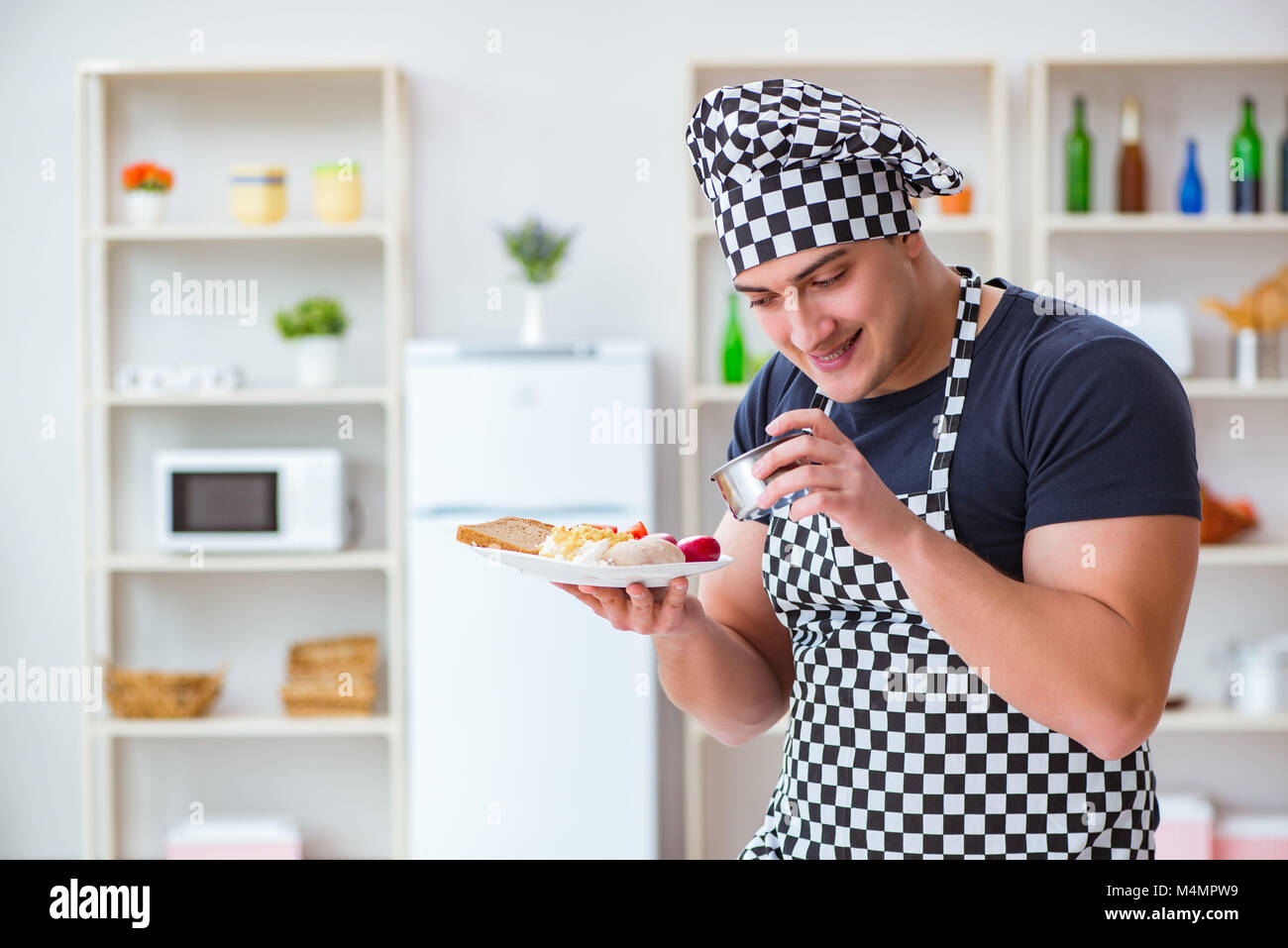Chef cook cooking a meal breakfast dinner in the kitchen Stock Photo ...