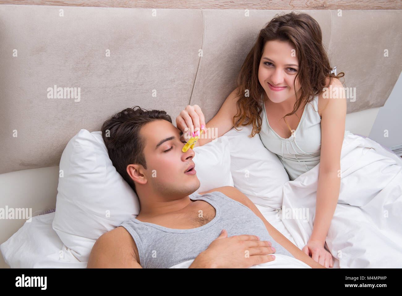 Woman having trouble with husband snoring Stock Photo - Alamy