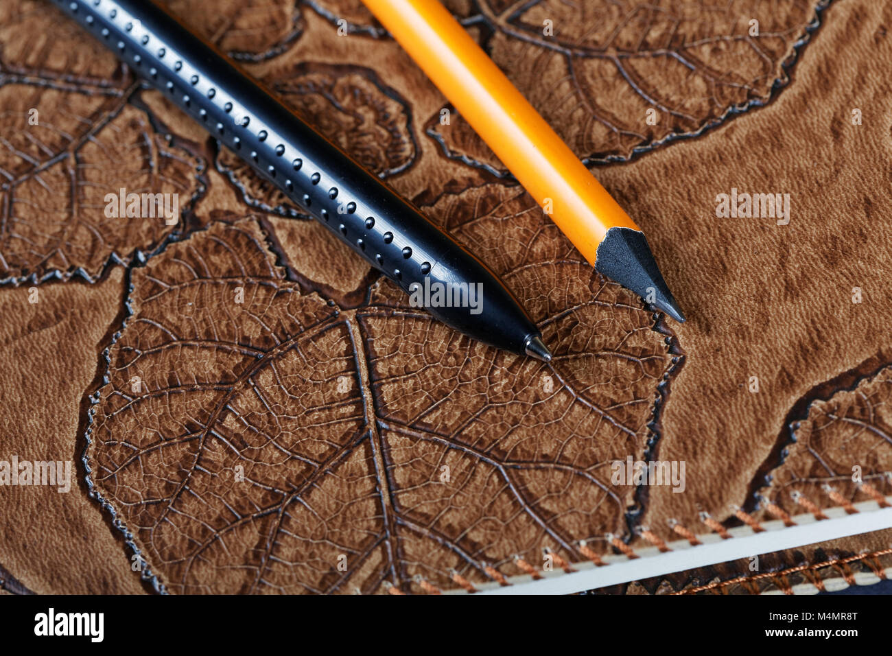 notebooks in leather covers and a pencil close up Stock Photo - Alamy