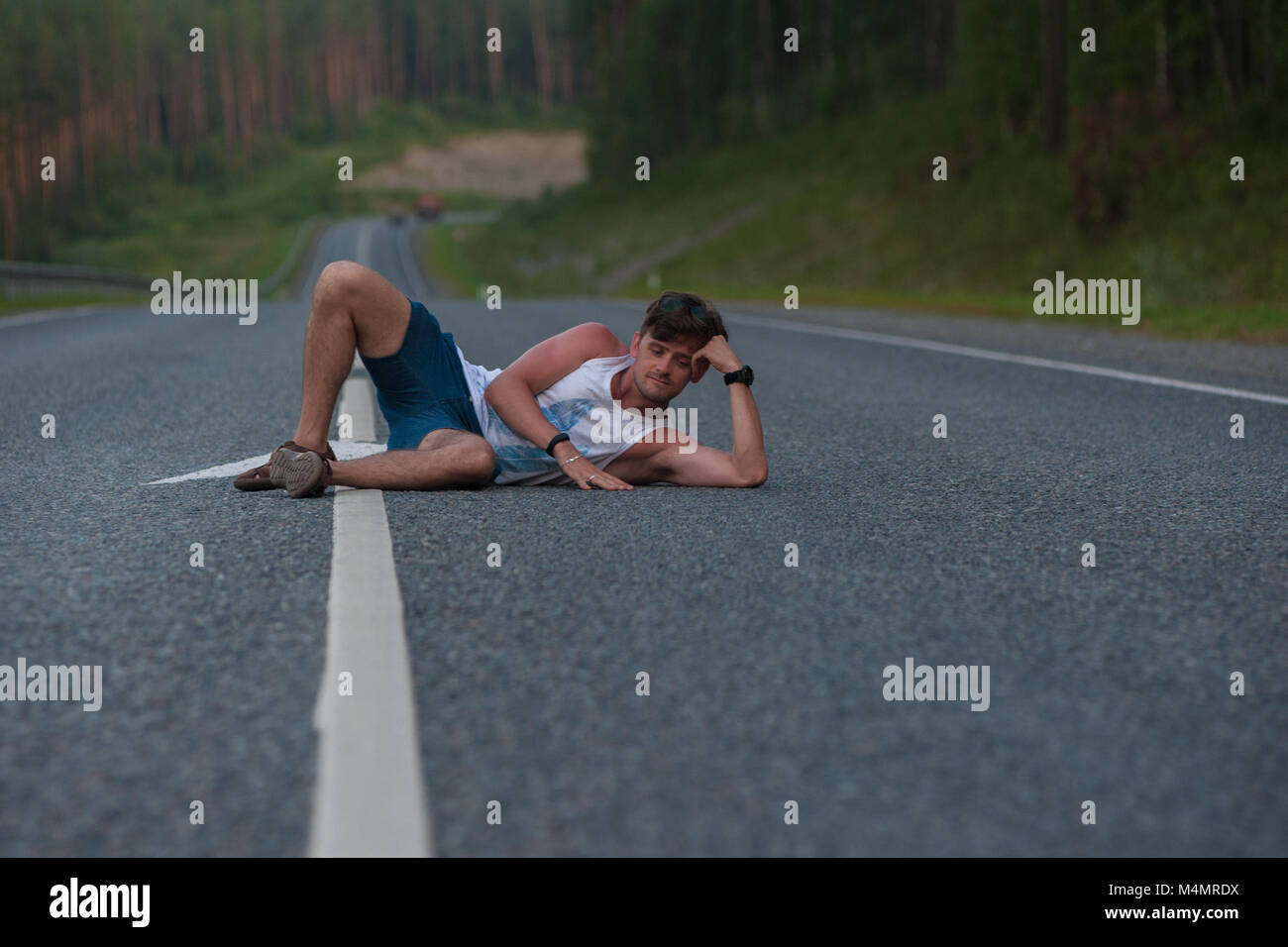 Man laying on the road Stock Photo - Alamy