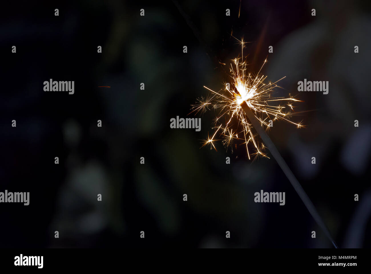 Glowing holiday sparkling hand fireworks Stock Photo - Alamy