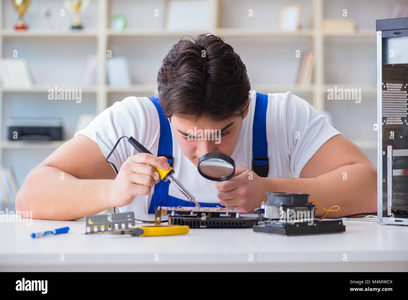 Computer repairman repairing desktop computer Stock Photo - Alamy