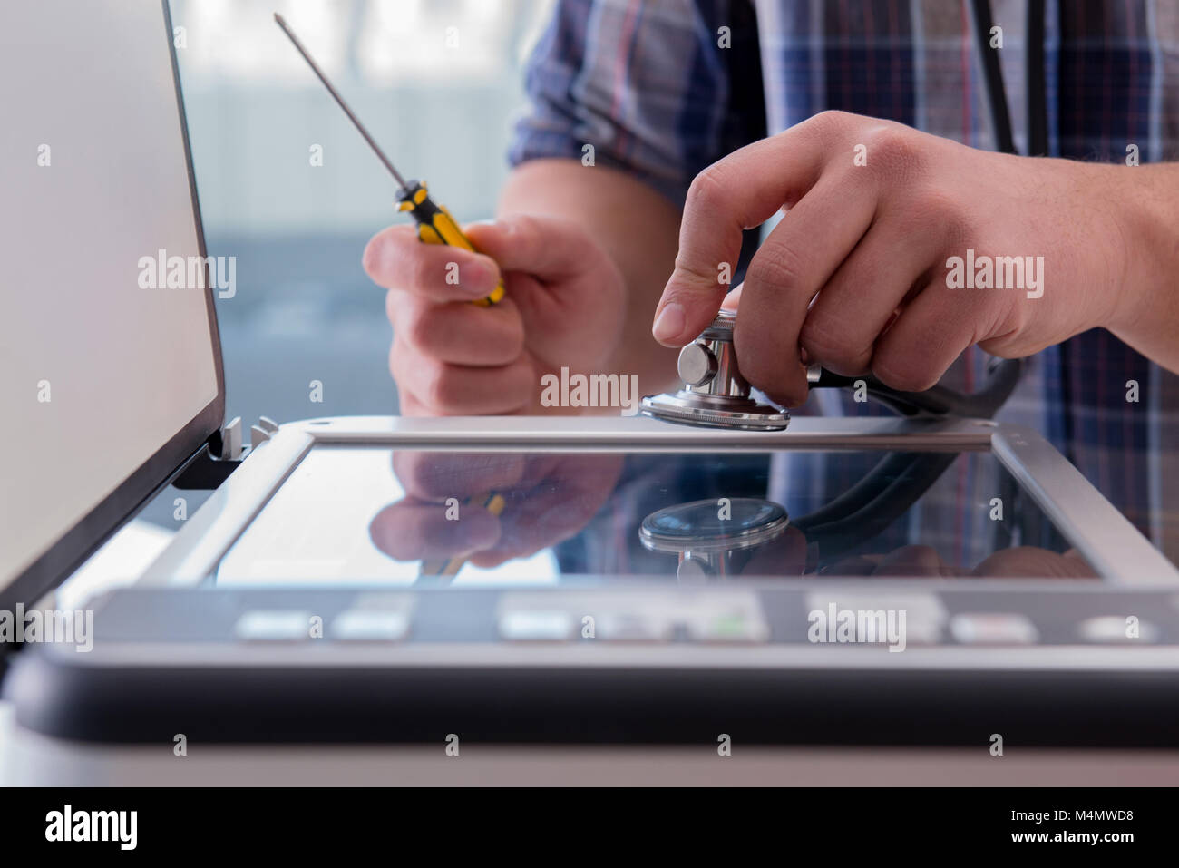 Repairman repairing broken color printer Stock Photo - Alamy