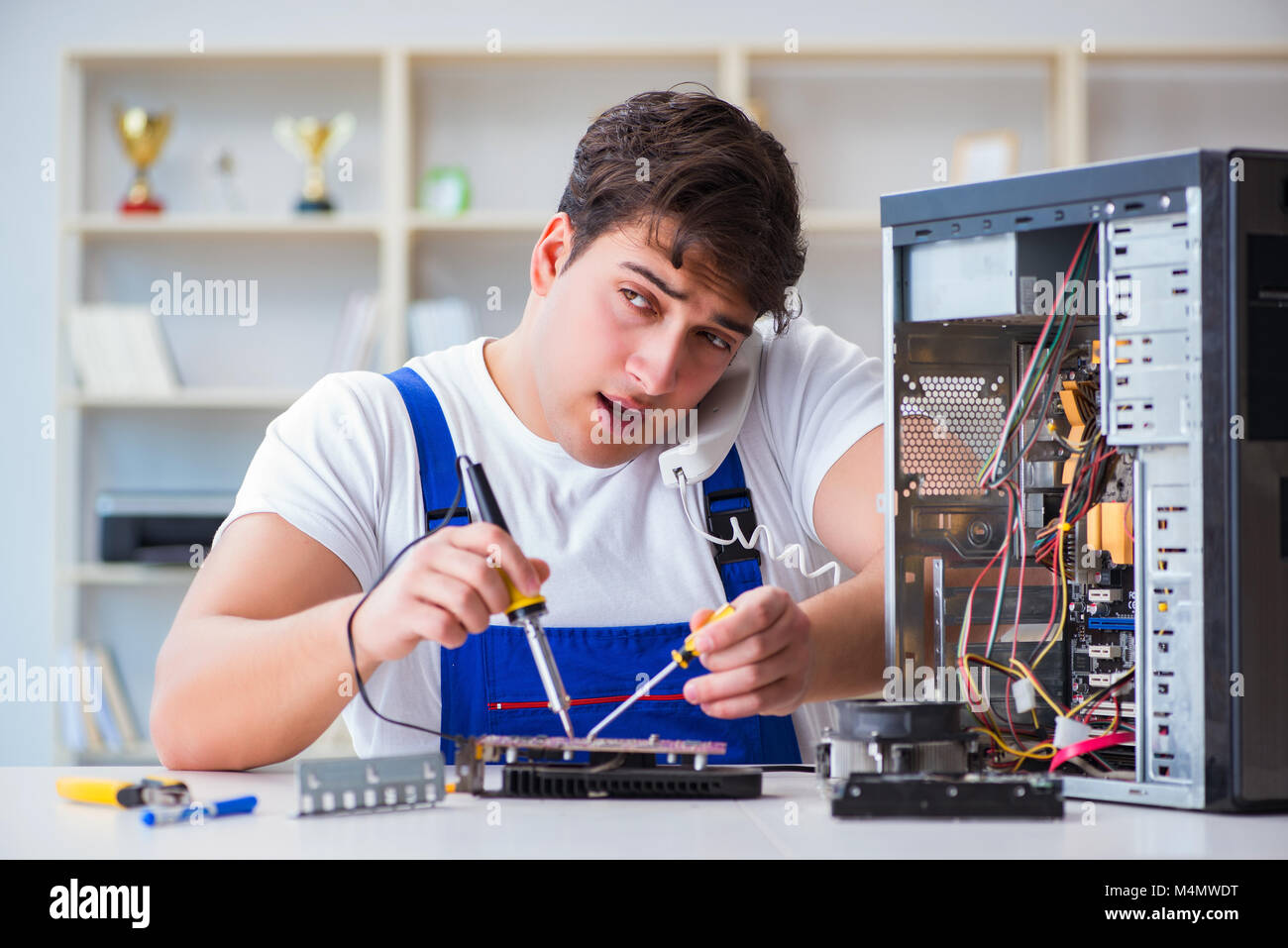 Computer repairman repairing desktop computer Stock Photo - Alamy