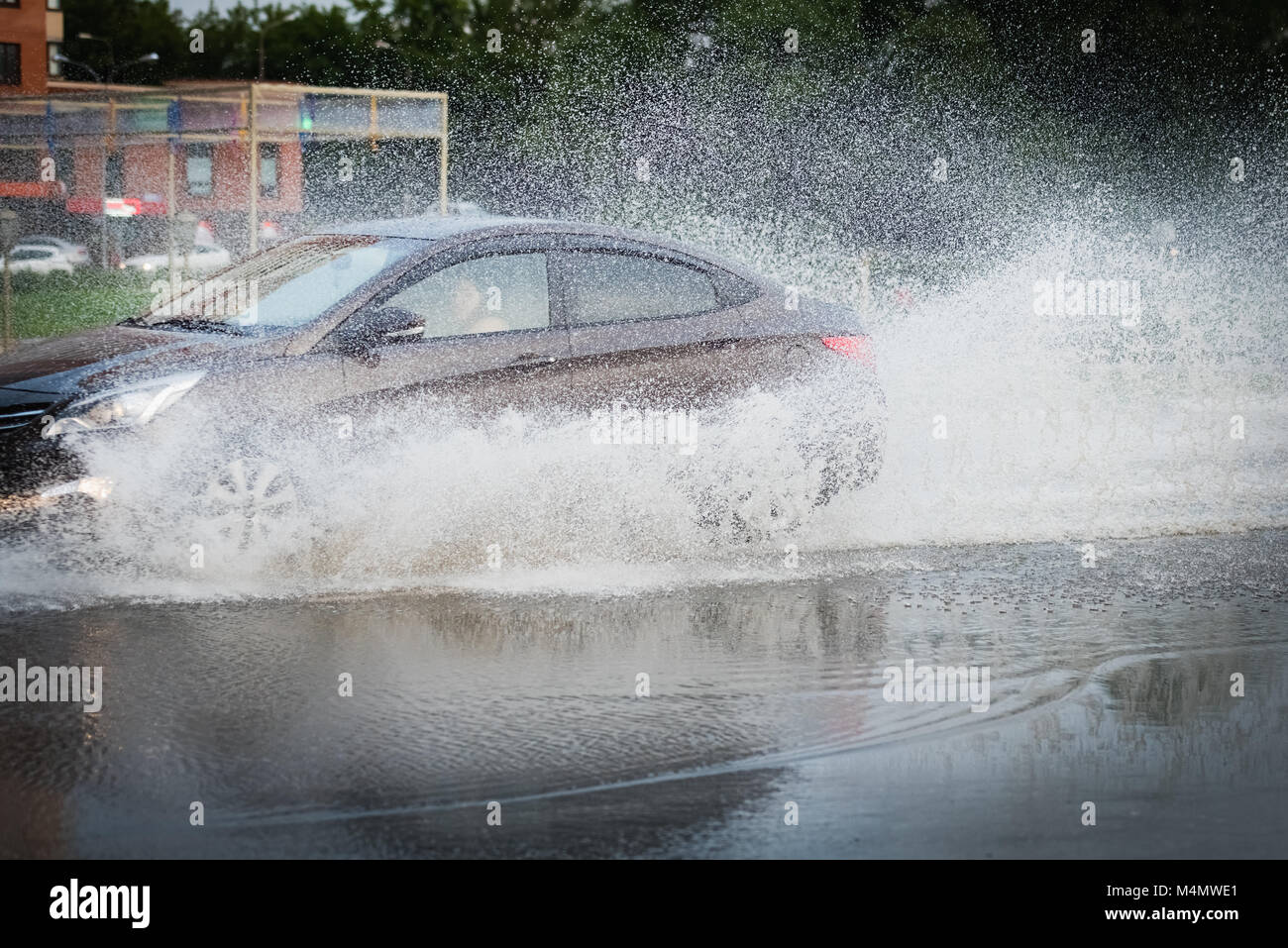 car rain puddle splashing water Stock Photo - Alamy