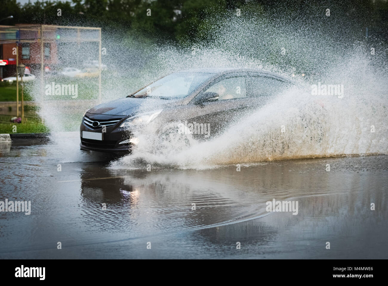 car rain puddle splashing water Stock Photo - Alamy