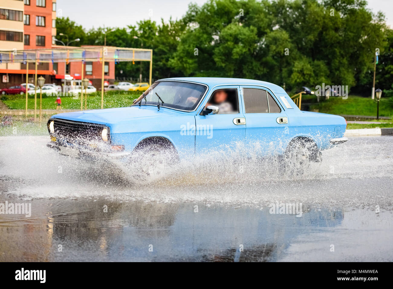 car rain puddle splashing water Stock Photo - Alamy