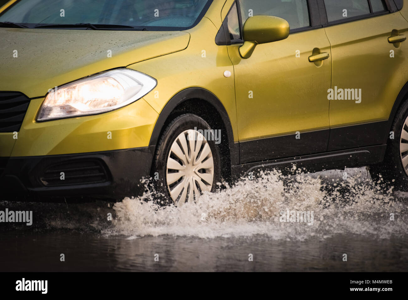 car rain puddle splashing water Stock Photo - Alamy
