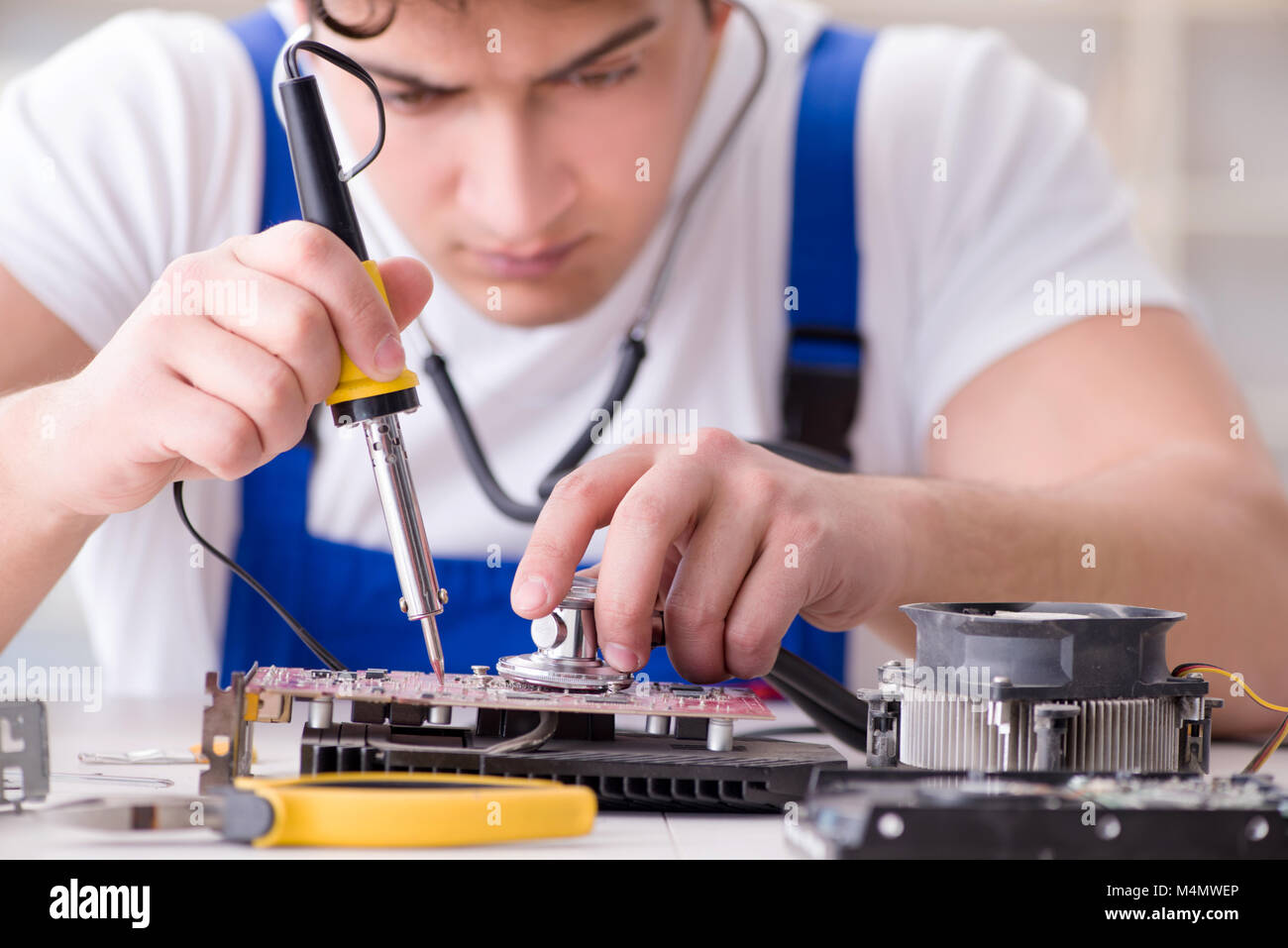 Computer repairman repairing desktop computer Stock Photo - Alamy