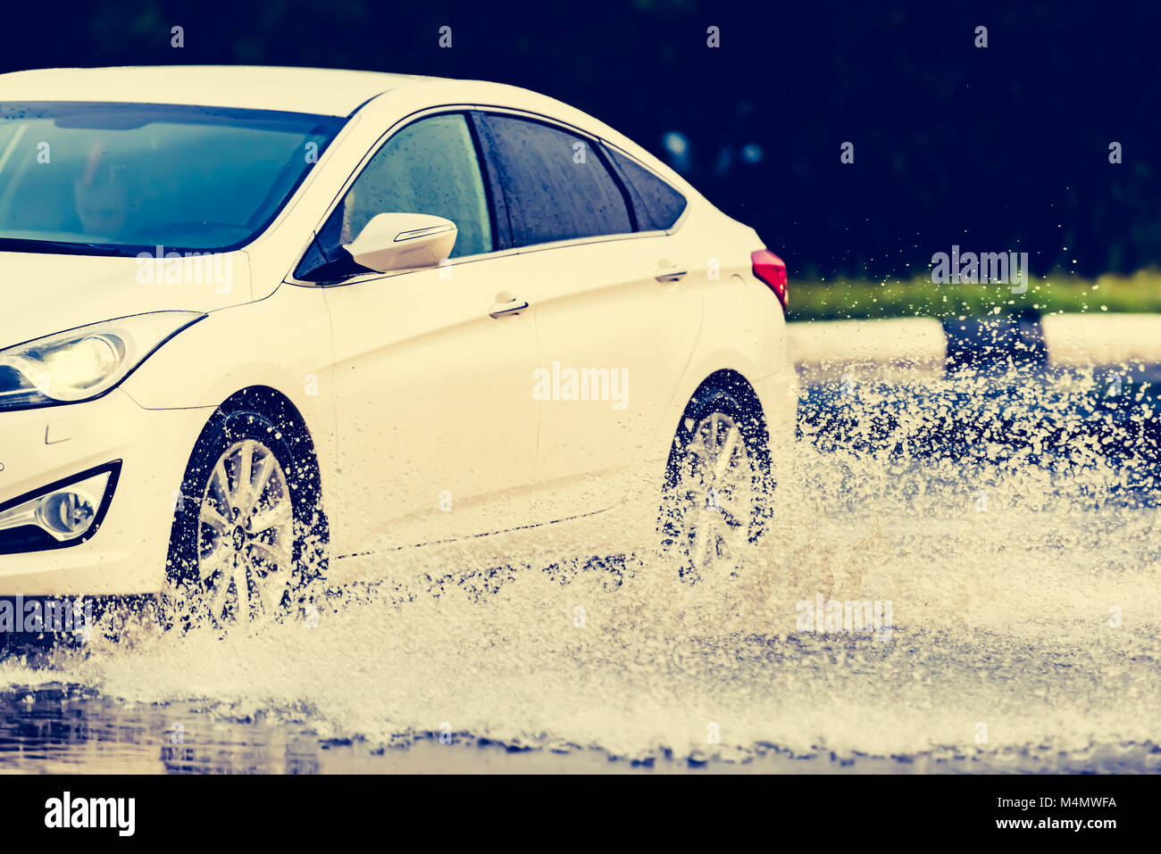 car rain puddle splashing water Stock Photo - Alamy