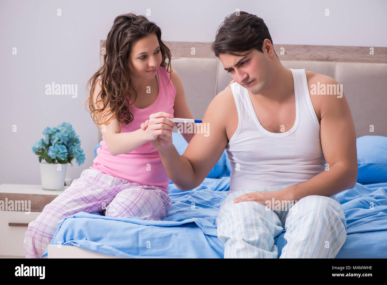 Young family with pregnancy test results Stock Photo - Alamy