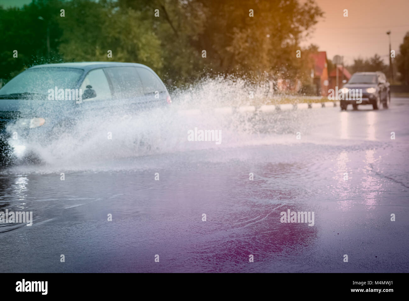 car rain puddle splashing water Stock Photo - Alamy