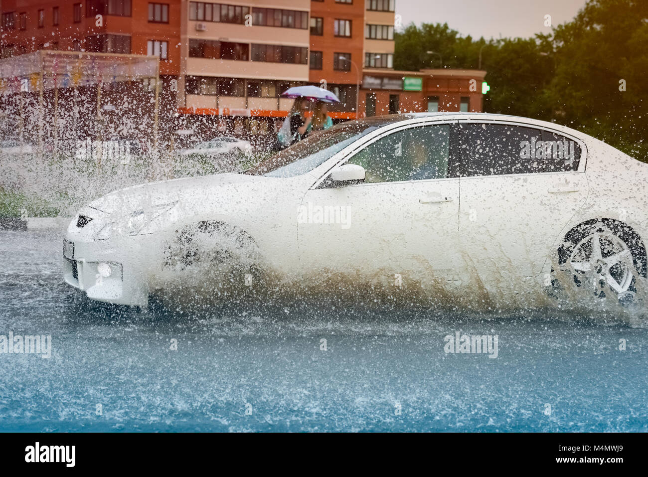car rain puddle splashing water Stock Photo - Alamy