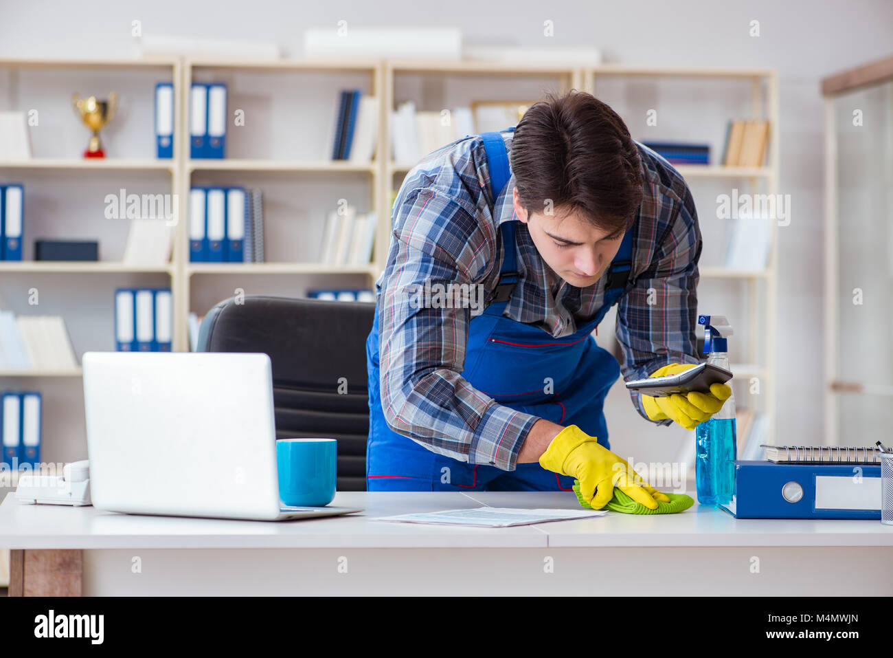 Male cleaner working in the office Stock Photo - Alamy