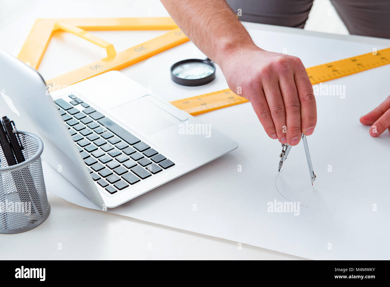 Male engineer working on drawings and blueprints Stock Photo - Alamy
