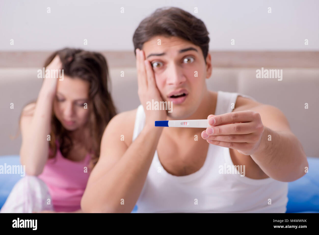 Young family with pregnancy test results Stock Photo - Alamy