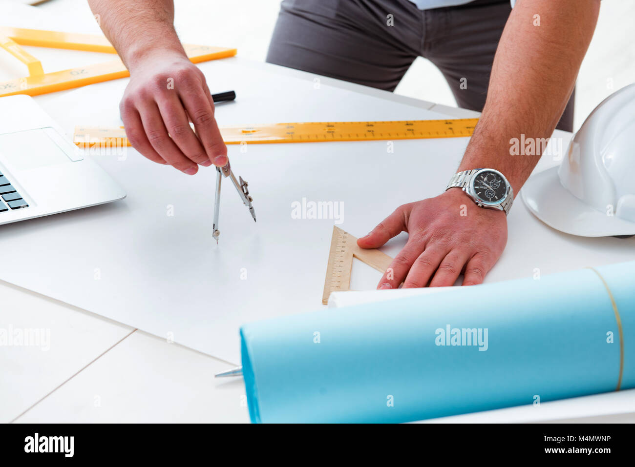 Male engineer working on drawings and blueprints Stock Photo - Alamy