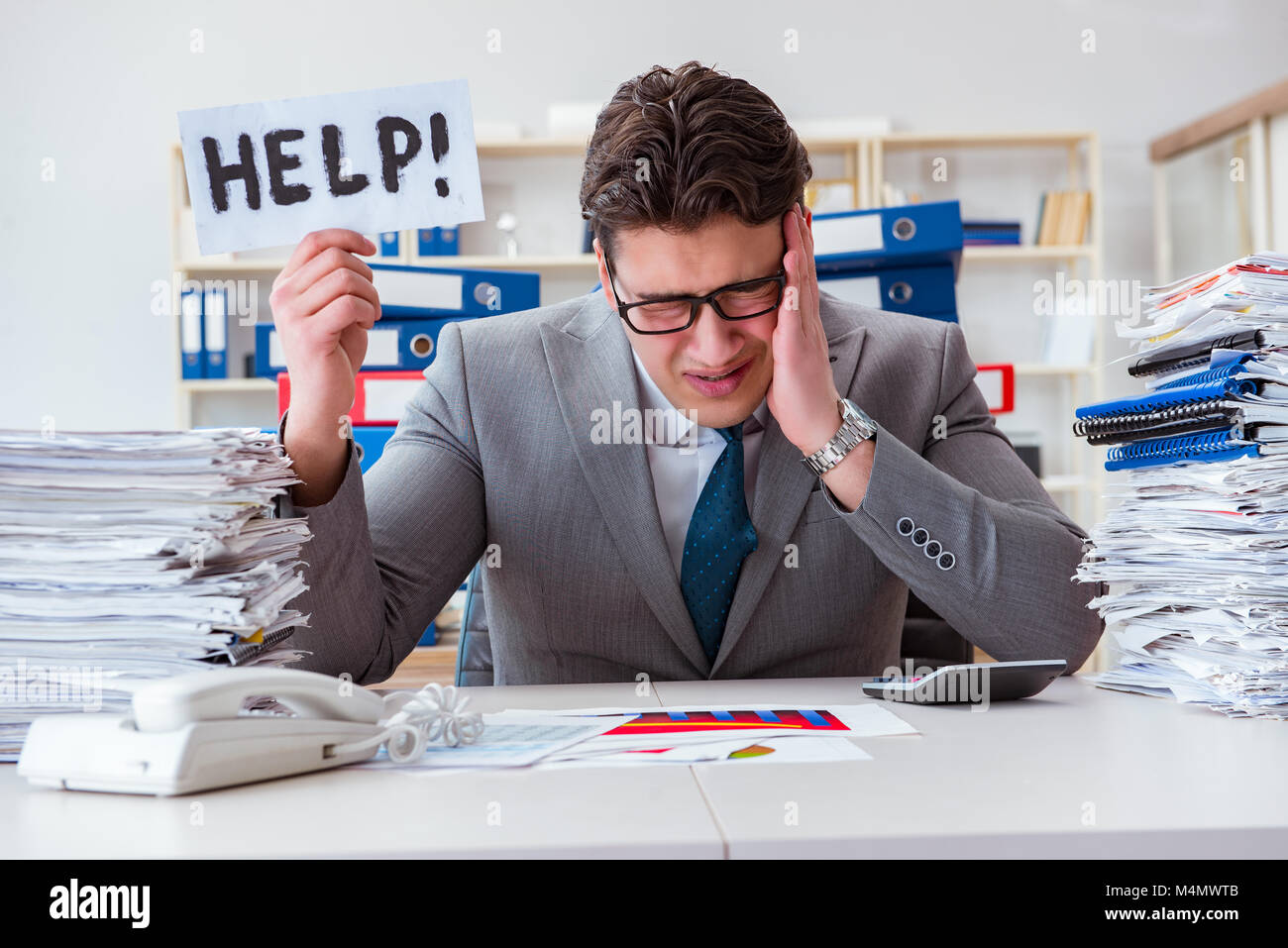 Businessman missing deadlines due to excessive work Stock Photo - Alamy