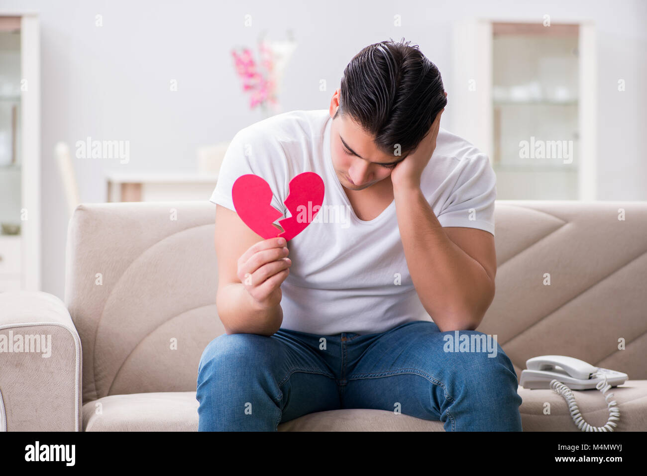 Young man in sad saint valentine concept Stock Photo - Alamy