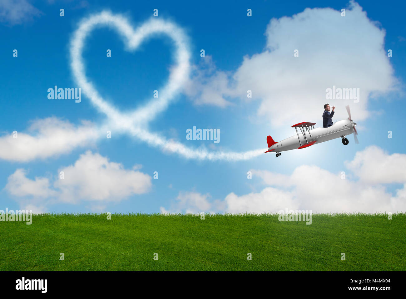 Man flying airplane and making heart shape Stock Photo - Alamy