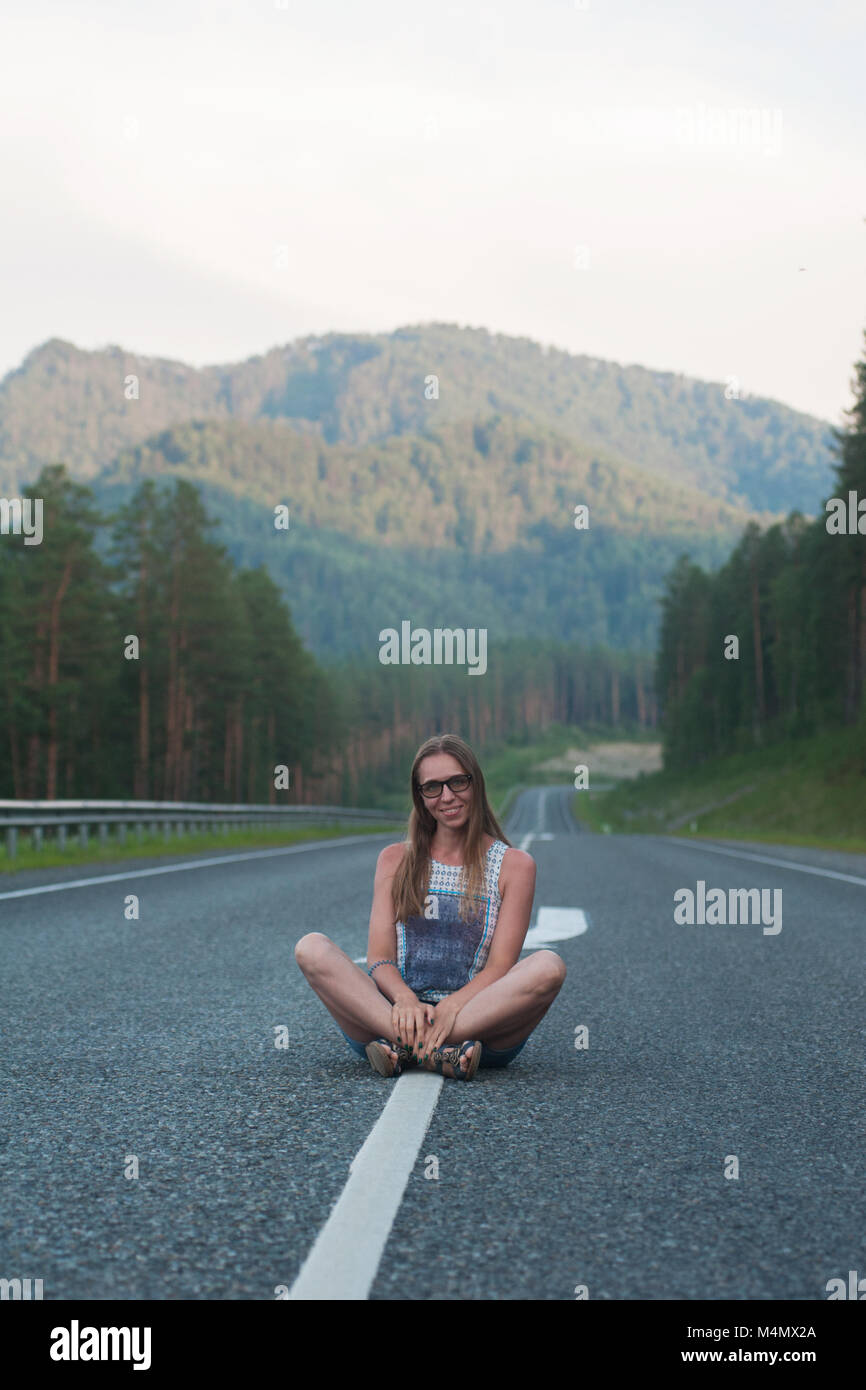 Woman sitting on the road Stock Photo - Alamy