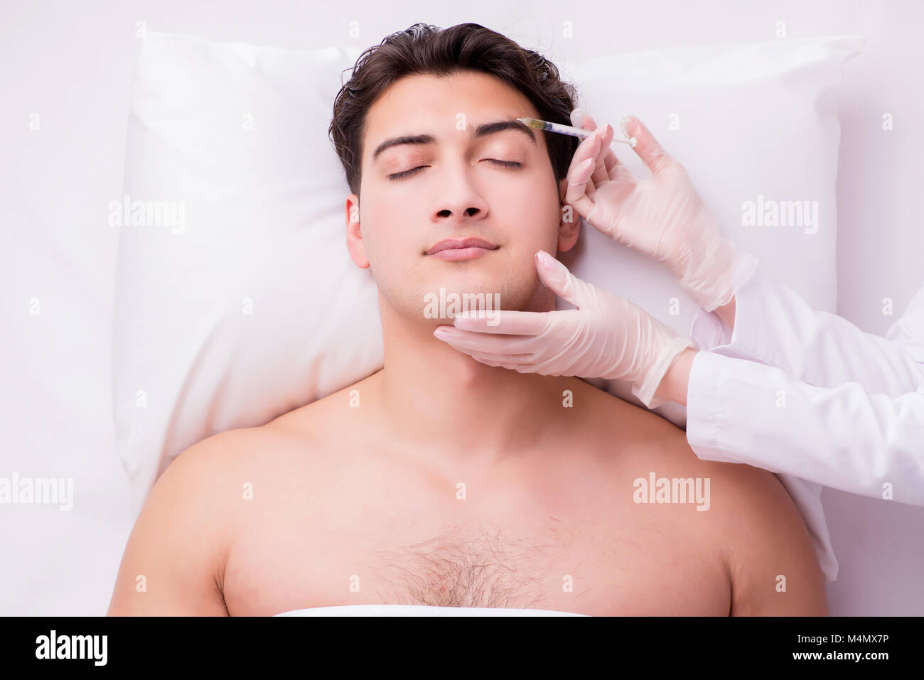Handsome man in spa massage concept Stock Photo - Alamy