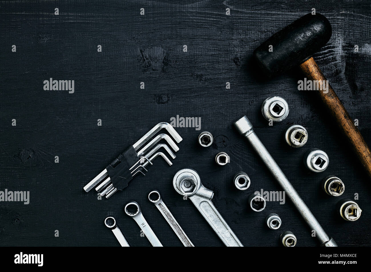 Renovating a car. A set of repair tools- hex keys, a hammer and a ...