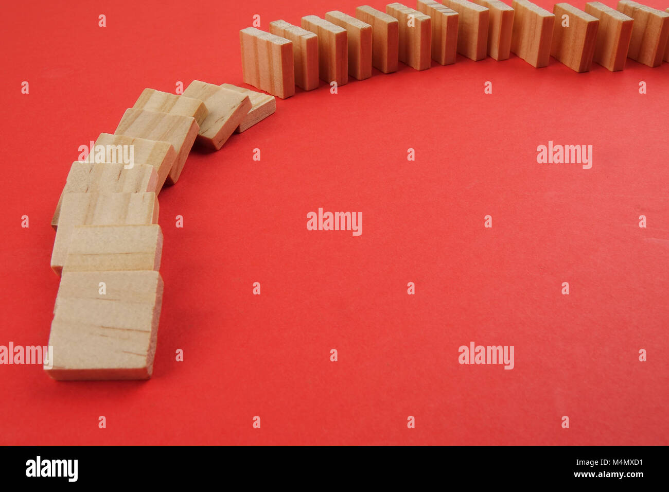 Domino effect isolated on red background. Selective focus Stock Photo ...