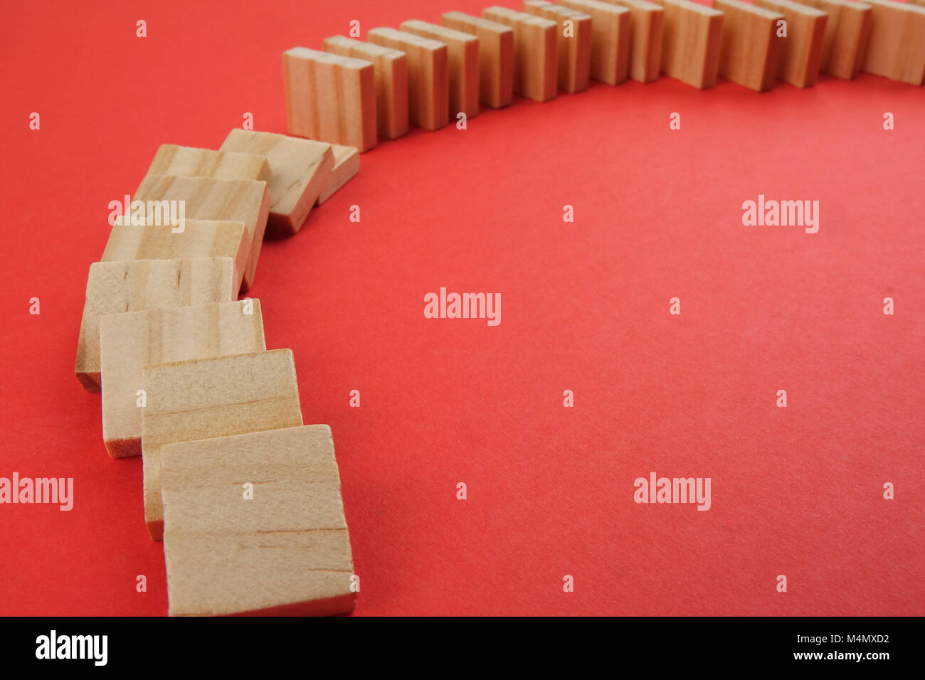 Domino effect isolated on red background. Selective focus Stock Photo ...
