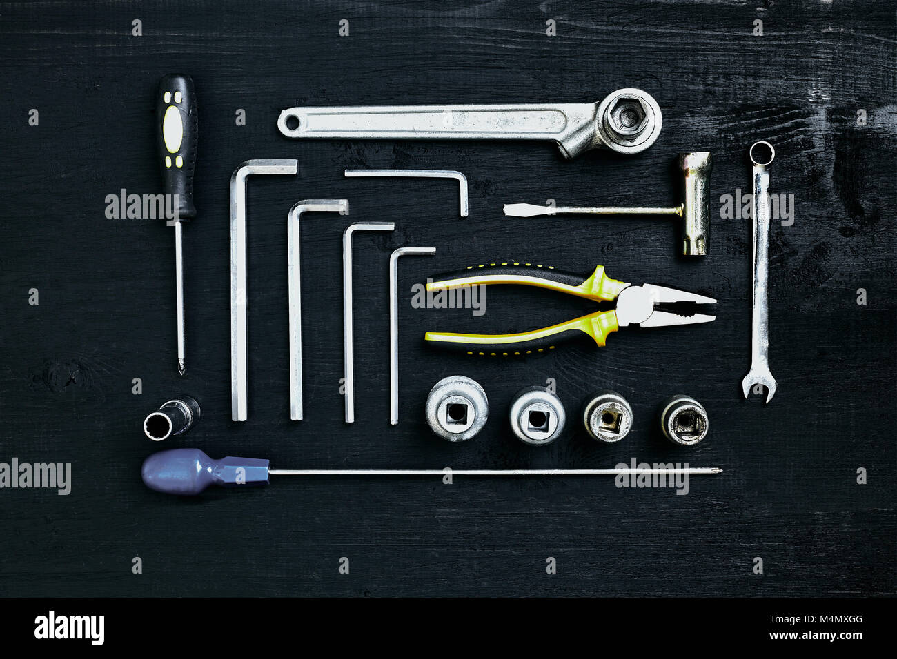 Wrench set of pliers socket spanner and screwdriver tools on black ...