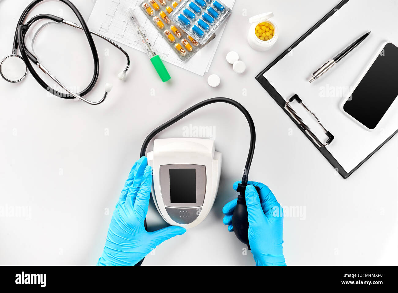 White electric tonometer on white table for measuring blood pressure ...