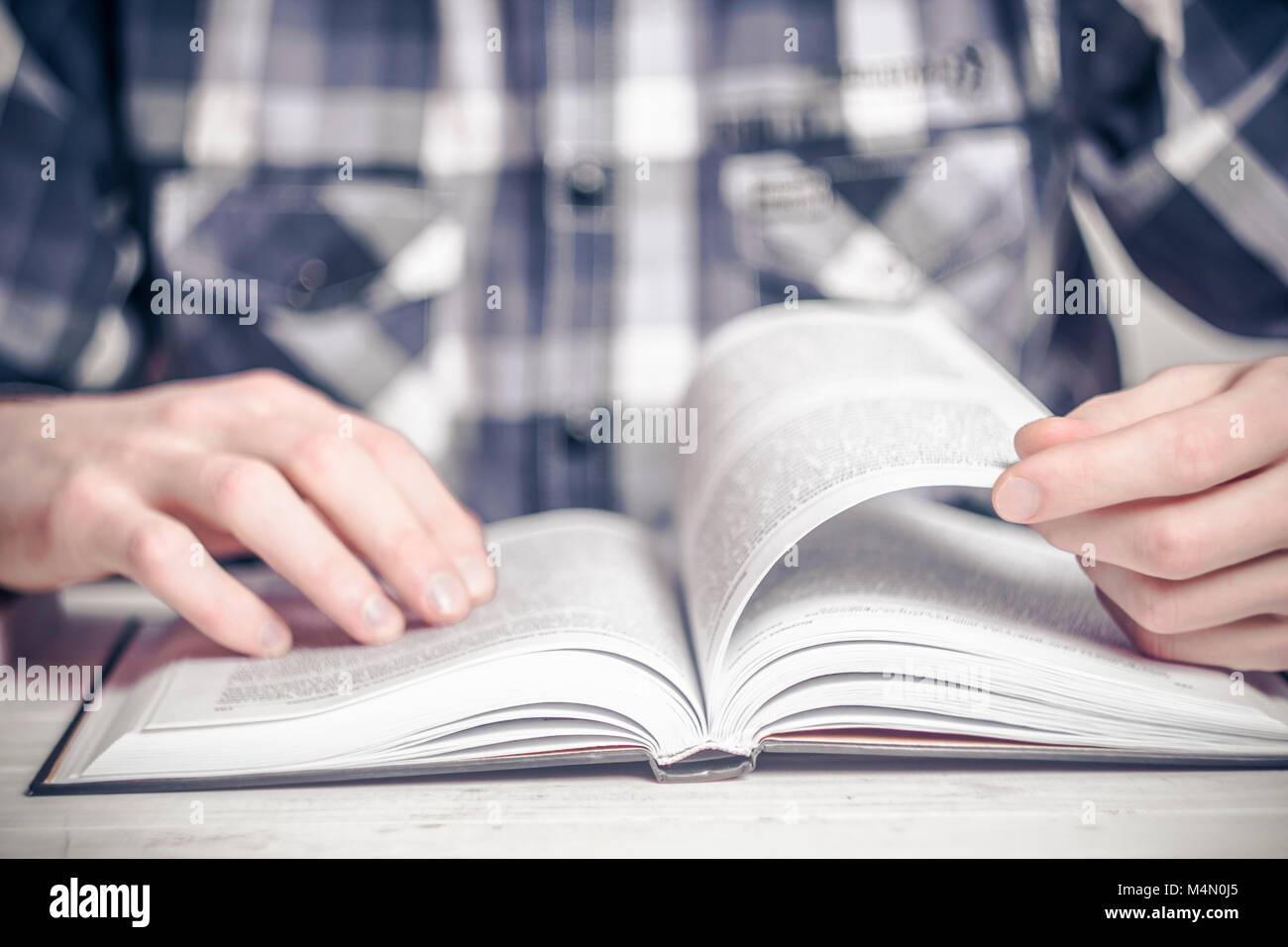 A man is reading a book Stock Photo - Alamy