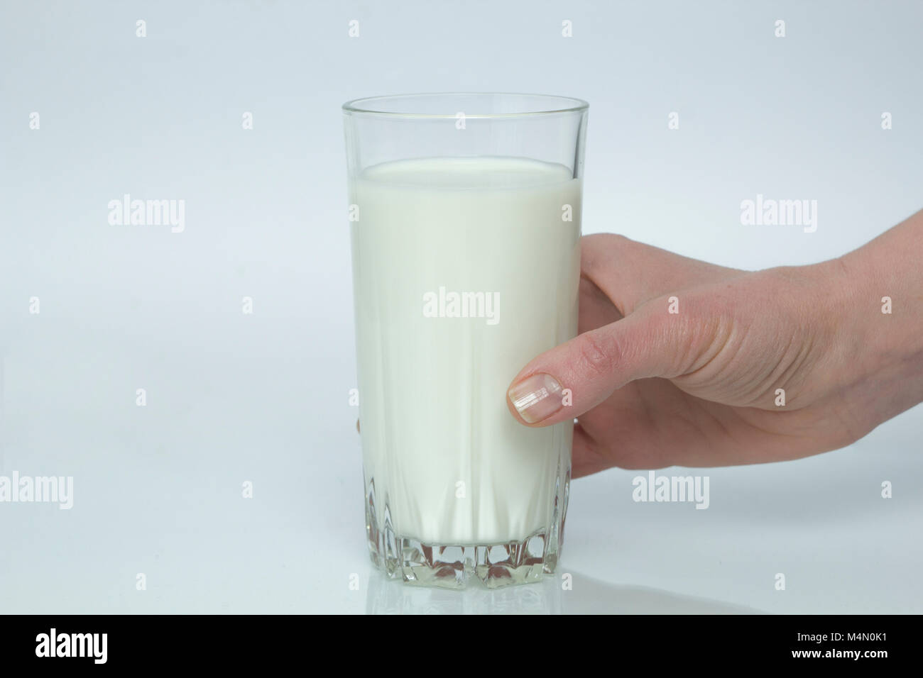 A glass of milk in hand Stock Photo - Alamy