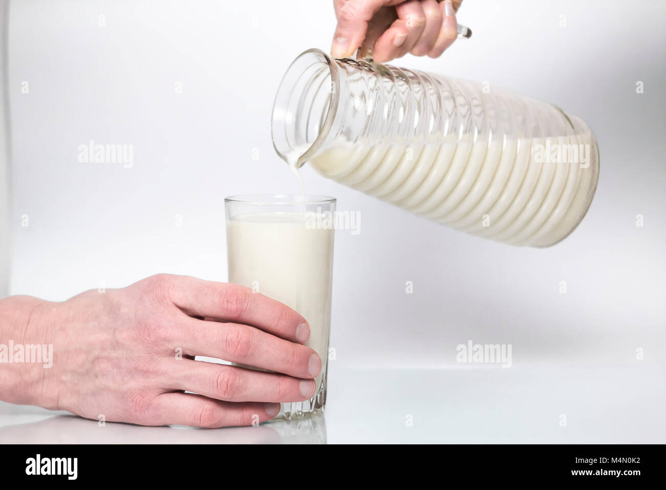 A glass of milk in hand Stock Photo - Alamy