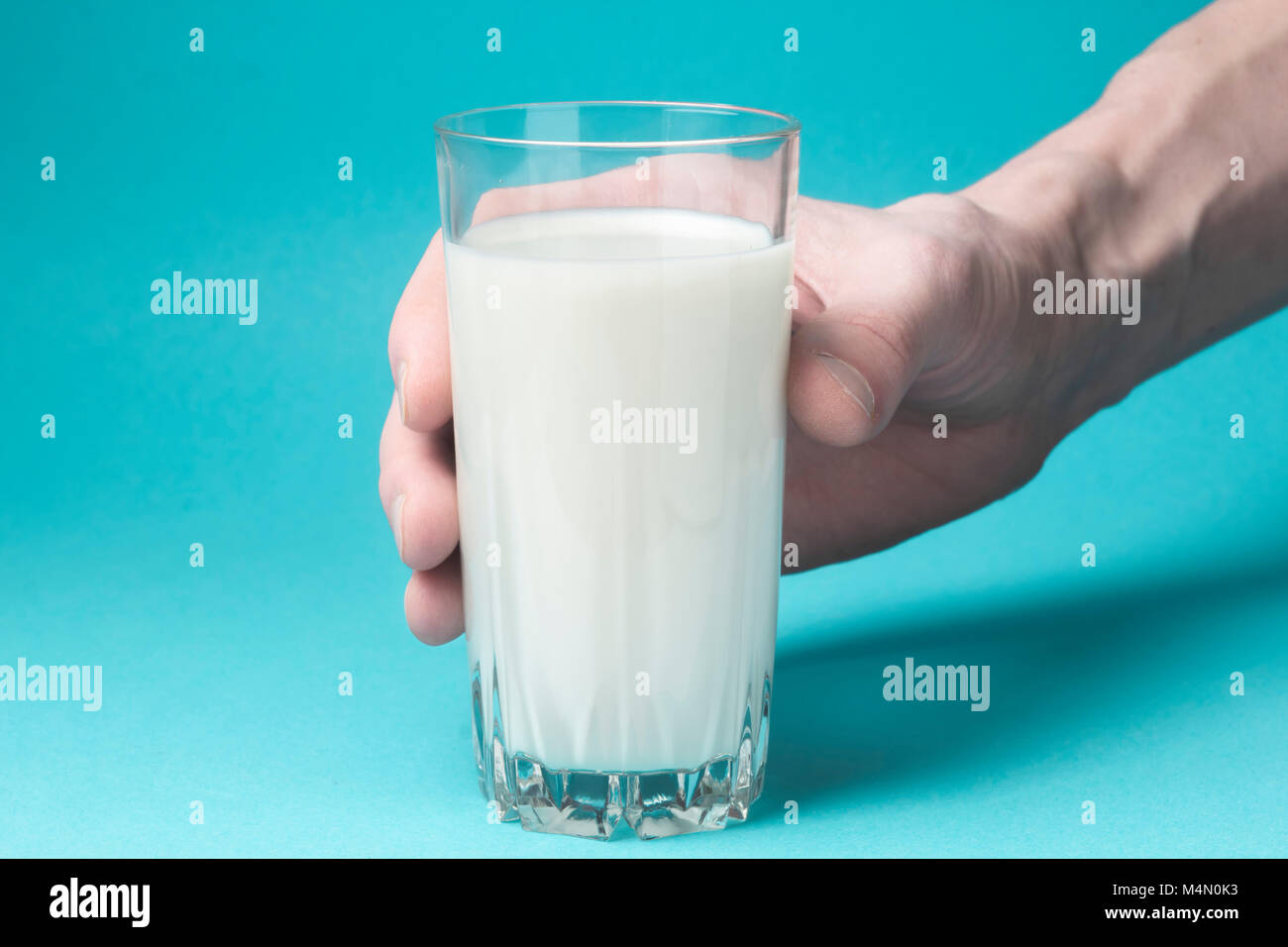 A glass of milk in hand Stock Photo - Alamy