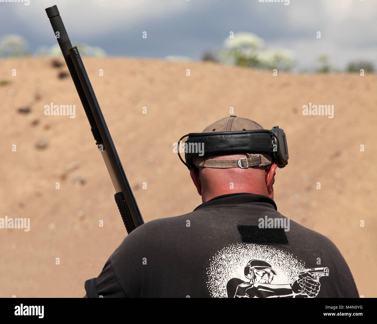 shooter with shotgun, rear view Stock Photo - Alamy