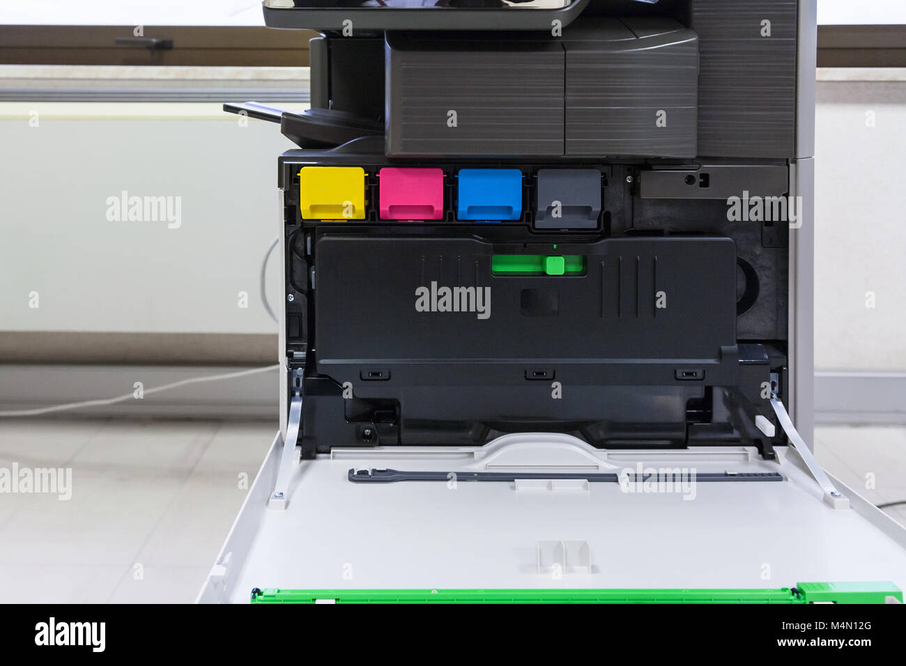 copier with four toner cartridges with open cover in office hall Stock ...