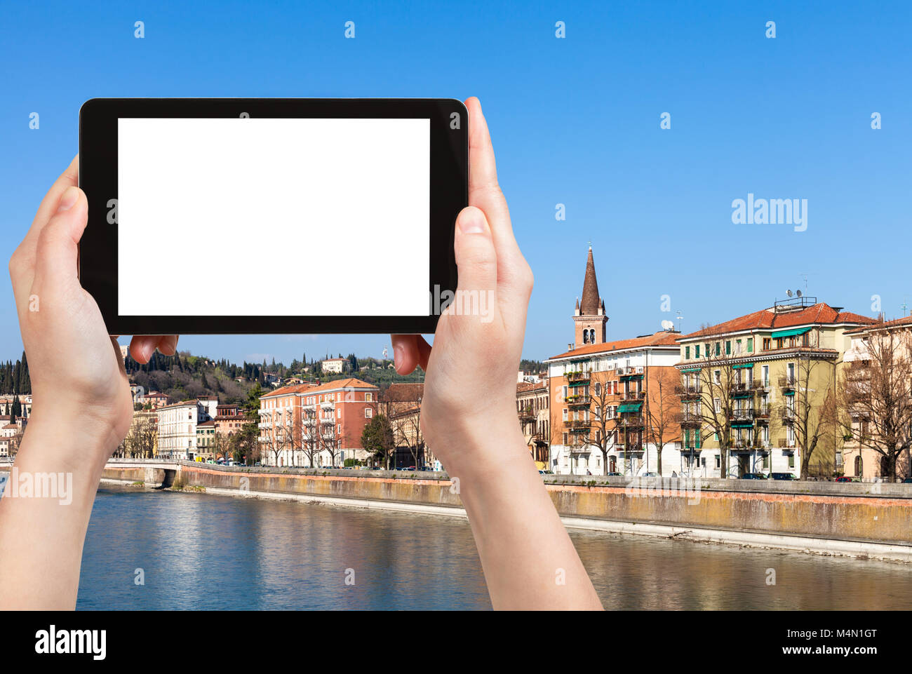 travel concept - tourist photographs waterfront in Verona city in sunny ...