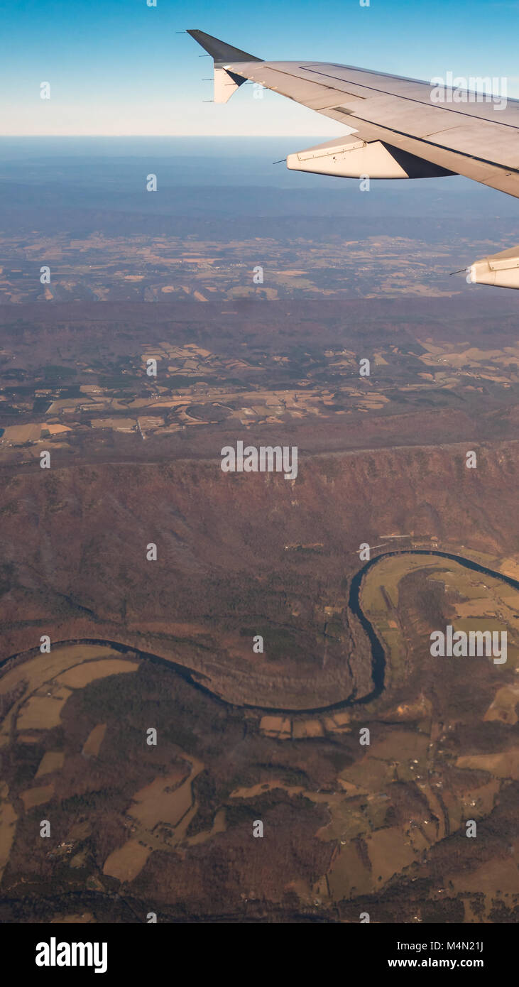 High Altitude Portrait View of Mountain Terrain from Airplane Window ...