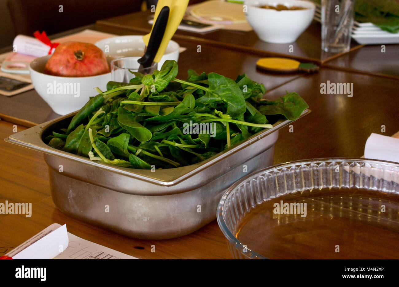 Fresh raw spinach in the metal bowl on a table Stock Photo - Alamy