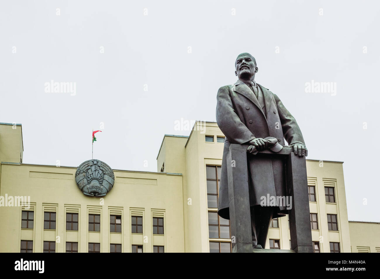 Lenin sculpture against the background of the Belarusian coat of arms ...